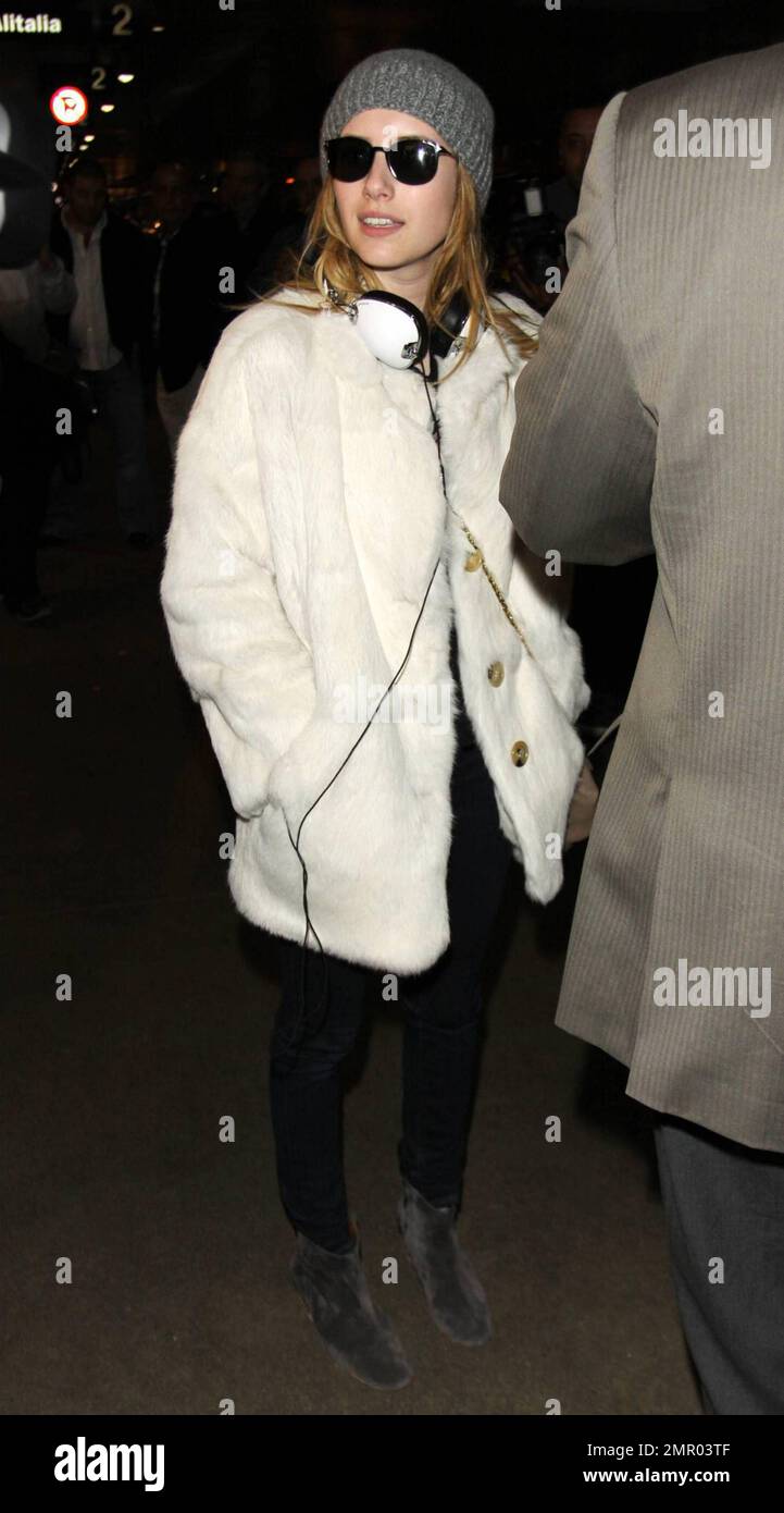 Actress Emma Roberts looks warm in a white fuzzy coat and grey hat as ...