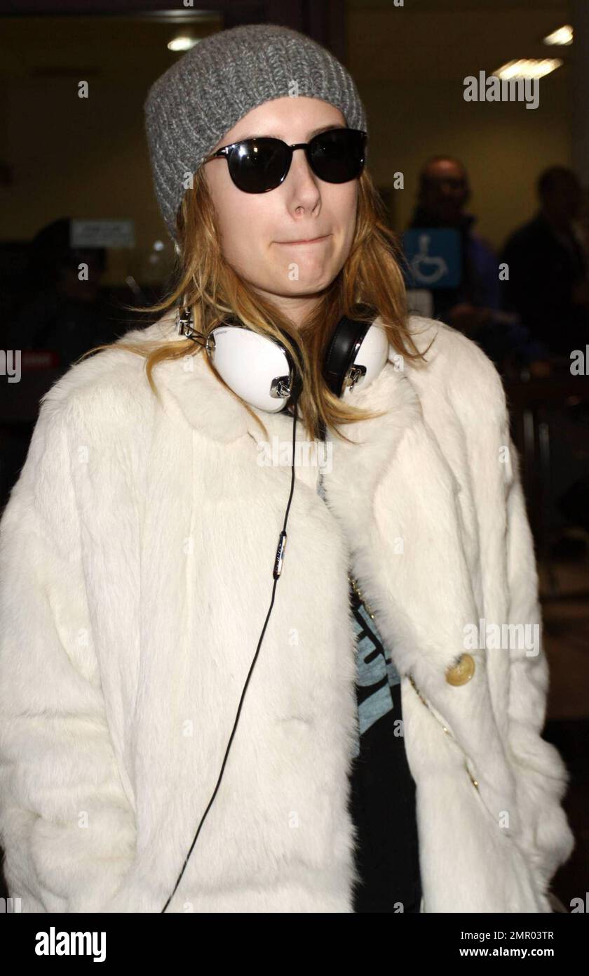 Actress Emma Roberts looks warm in a white fuzzy coat and grey hat as ...