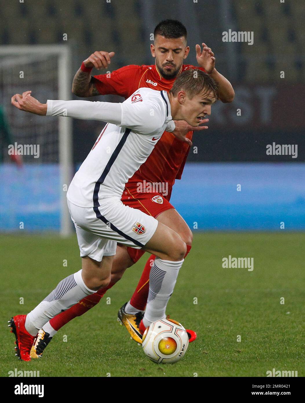 Norway's Martin Odegaard, front, with Macedonia's Aleksandar Trajkovski, rear, during the ...