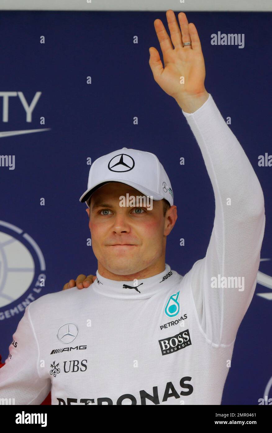 Mercedes driver Valtteri Bottas, of Finland, waves after he clocked the ...