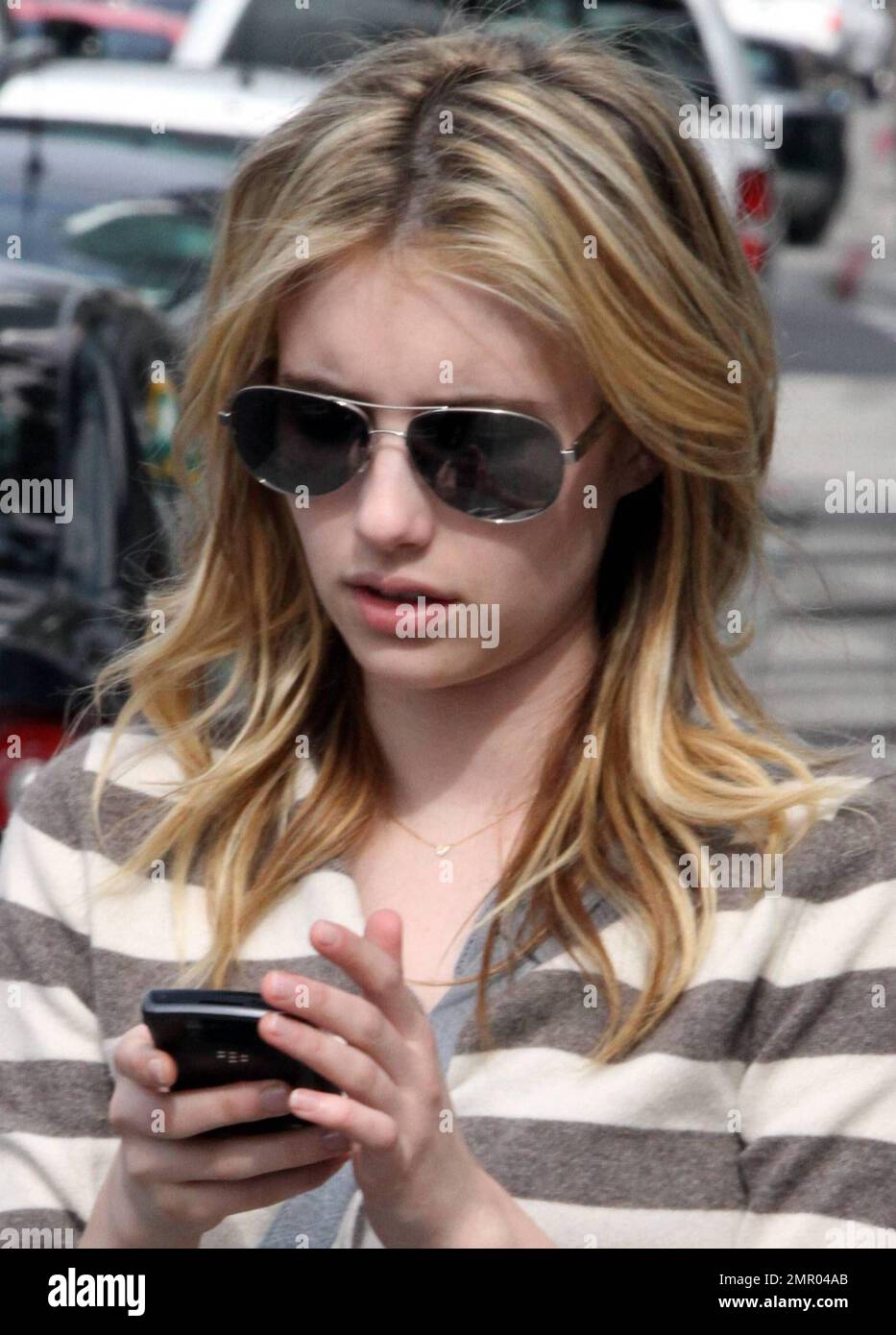 Wearing a striped top, black jeans and salon sandals, actress Emma ...