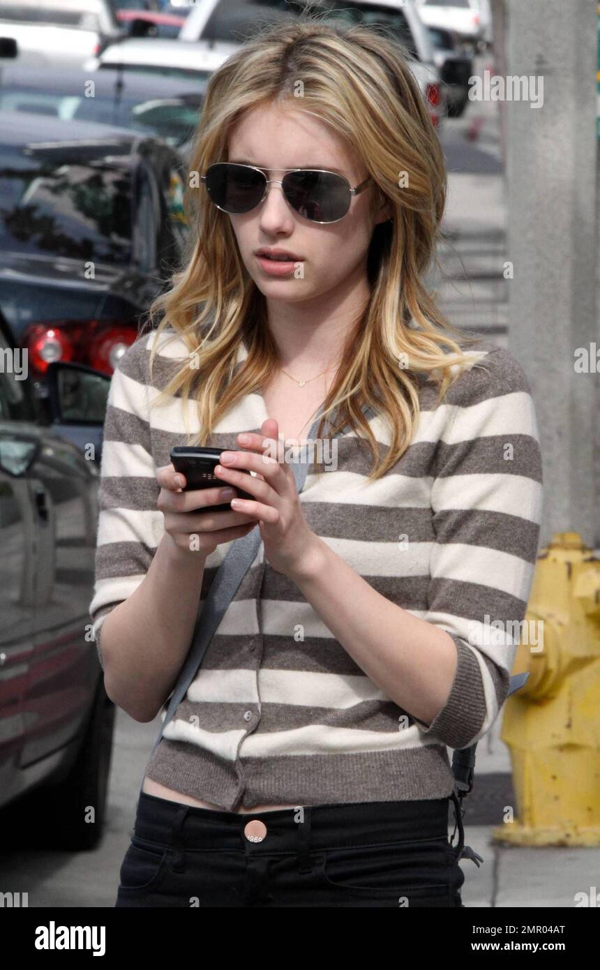 Wearing a striped top, black jeans and salon sandals, actress Emma ...