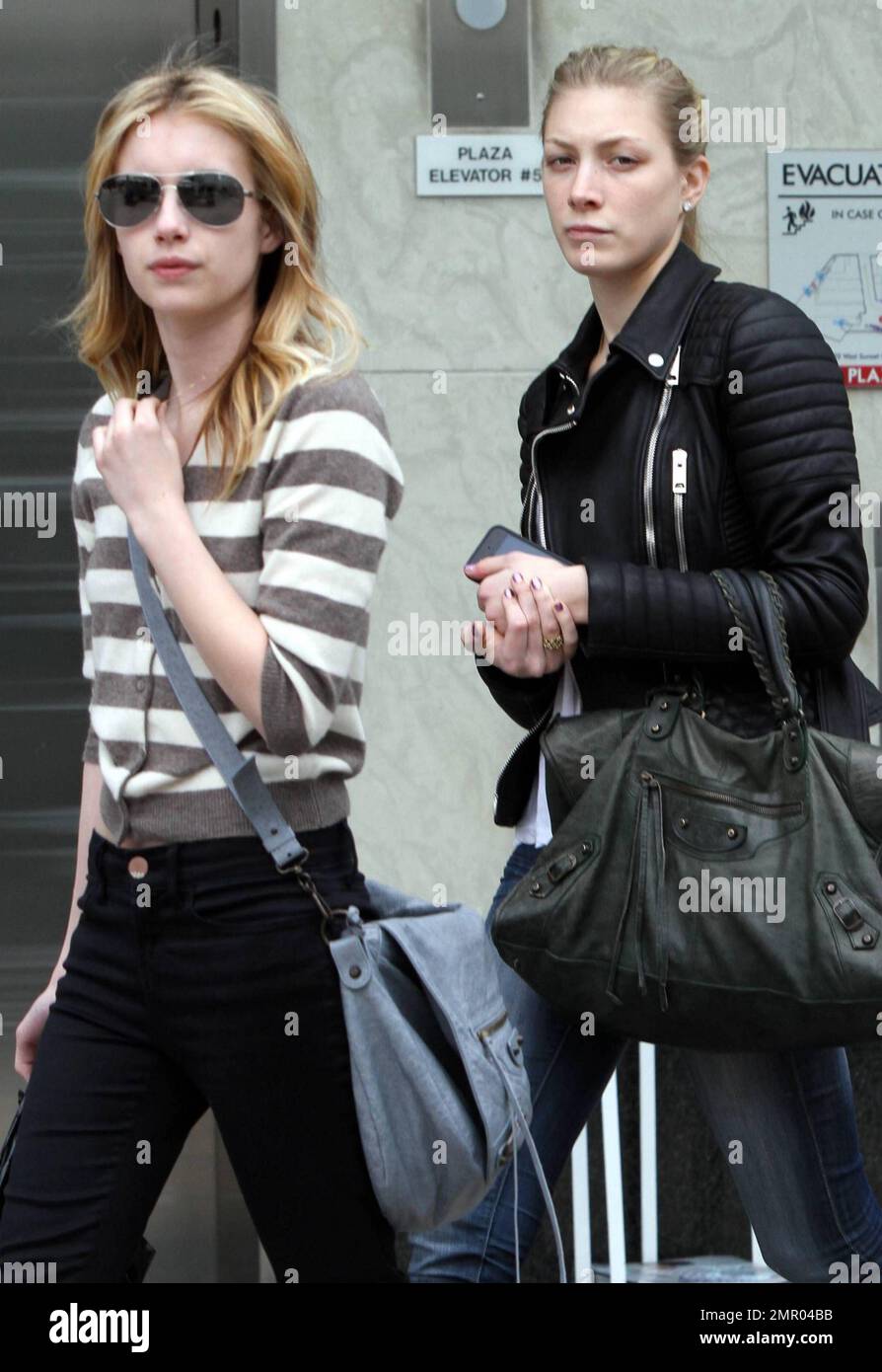 Wearing a striped top, black jeans and salon sandals, actress Emma ...