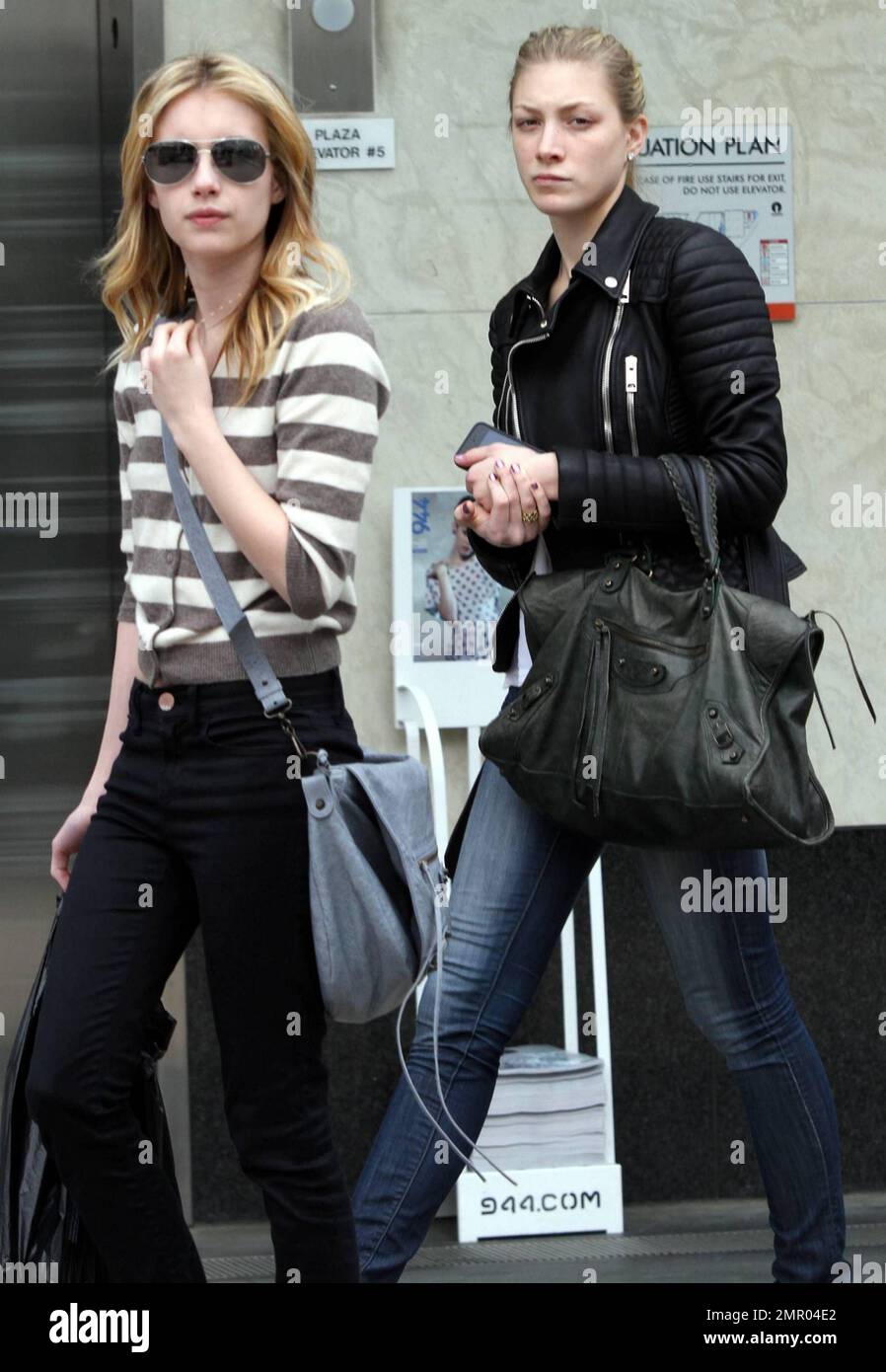 Wearing a striped top, black jeans and salon sandals, actress Emma ...