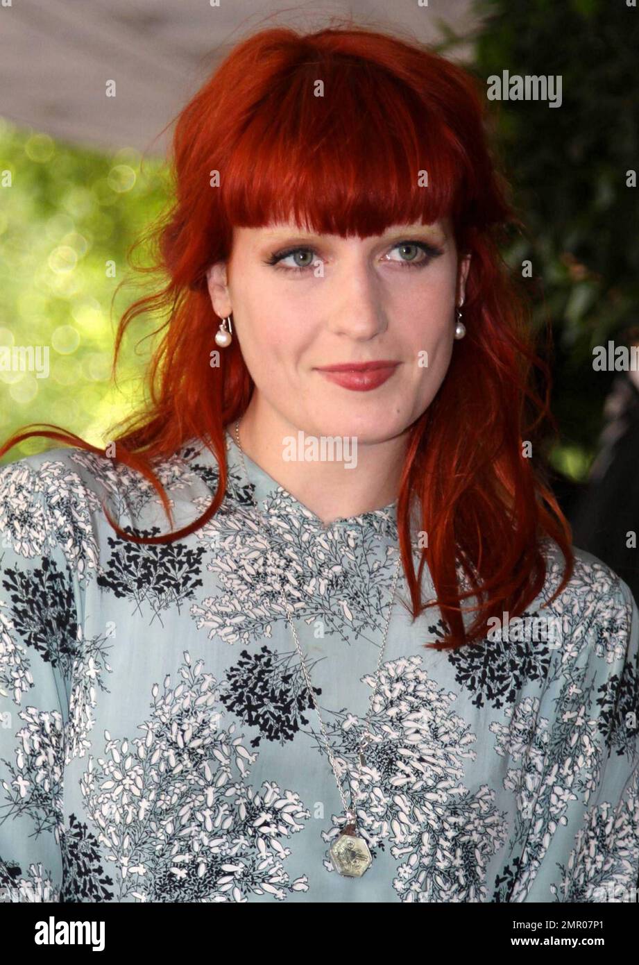 Florence Welch, lead singer of Florence and the Machine, shows off her trademark red hair and ...