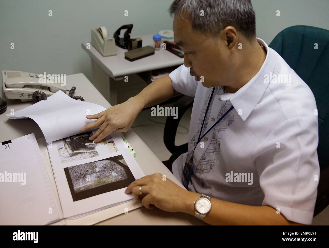 State Prosecutor Senior Assistant Peter Ong points at pictures from the ...
