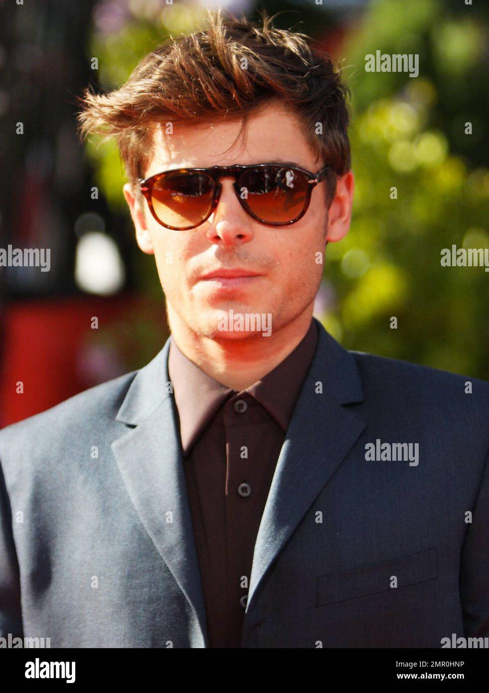 Zac Efron shows off a wild hairdo as he walks the red carpet for the ...