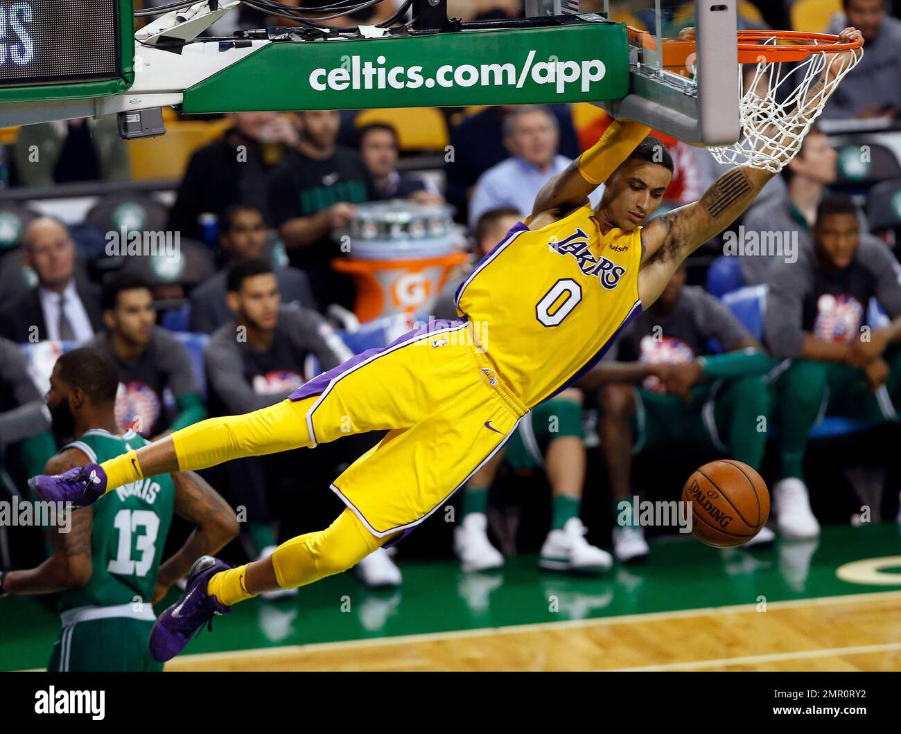 Los Angeles Lakers forward Kyle Kuzma swings from the rim after dunking ...
