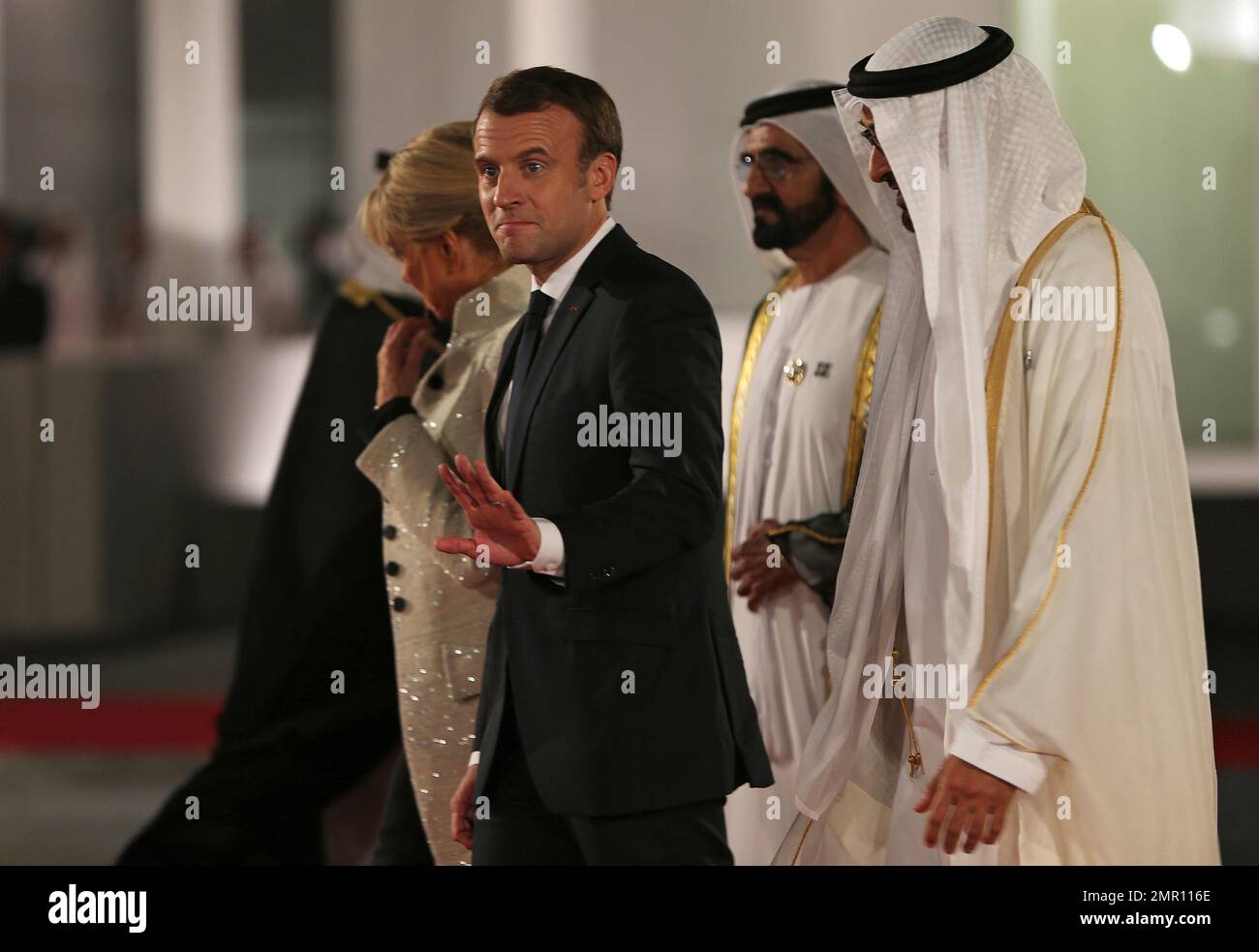 French President Emmanuel Macron waves to the cameras as he arrives for ...
