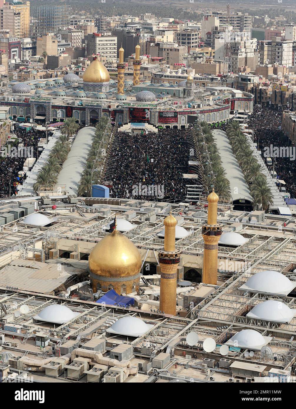 This aerial photo shows Shiite faithful pilgrims gather between, the ...