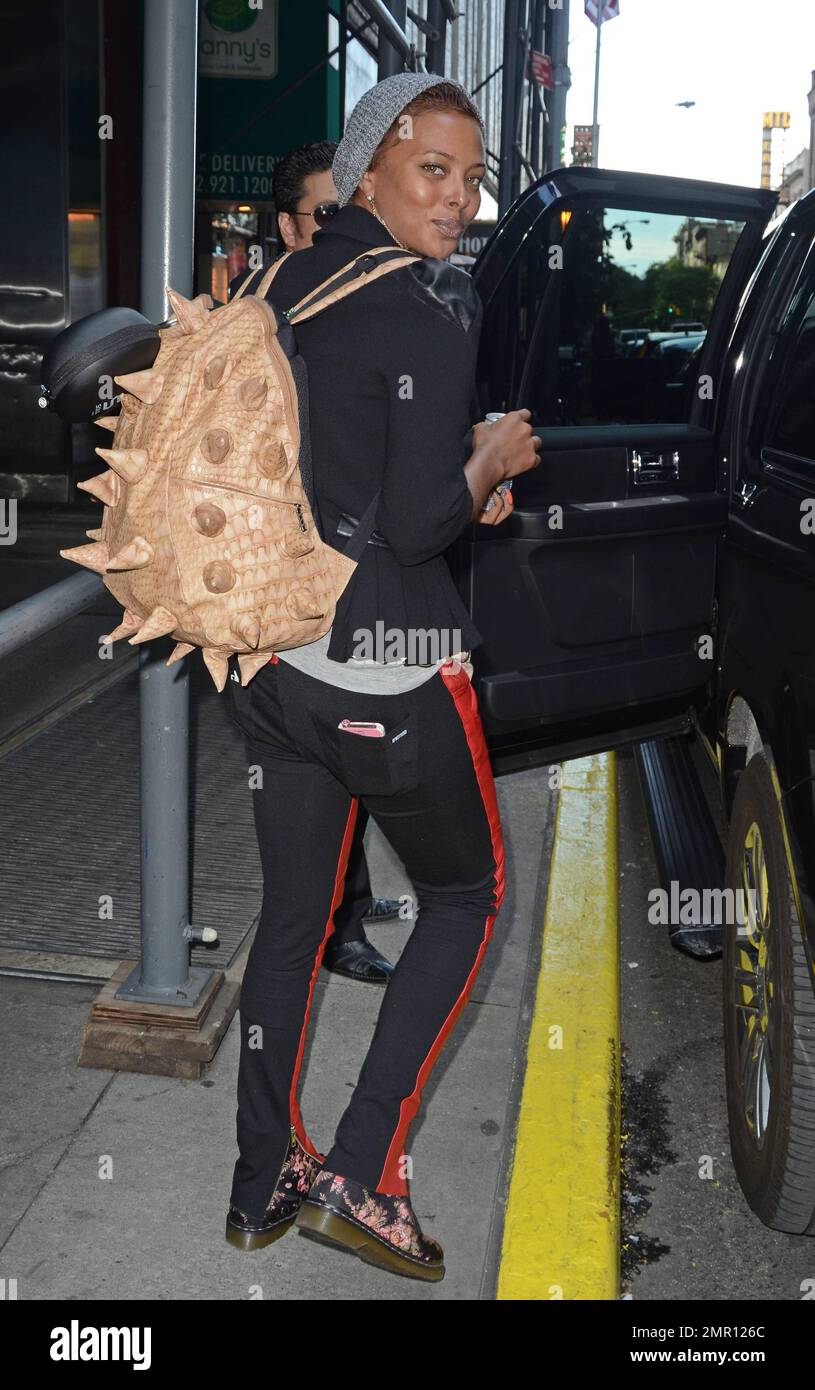 Wearing a grey stocking cap paired with a black jacket, grey top and ...