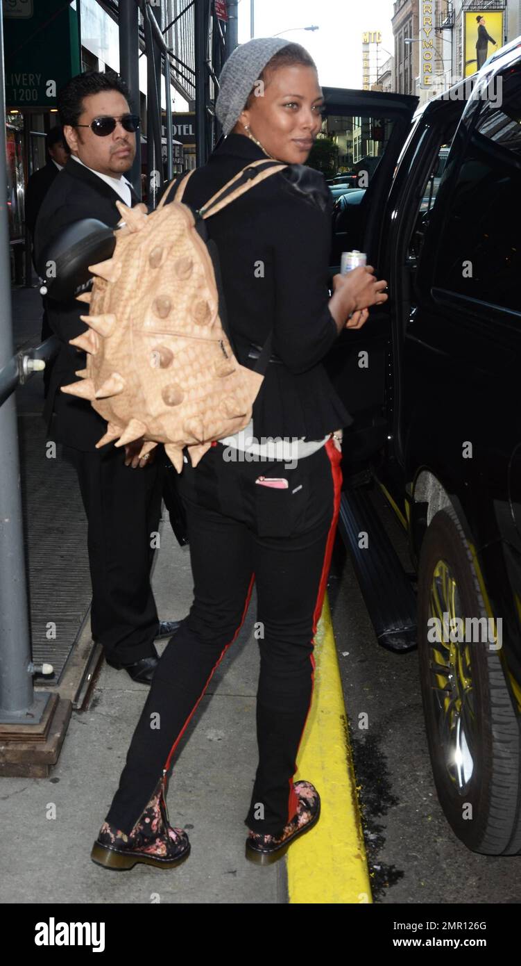 Wearing a grey stocking cap paired with a black jacket, grey top and ...