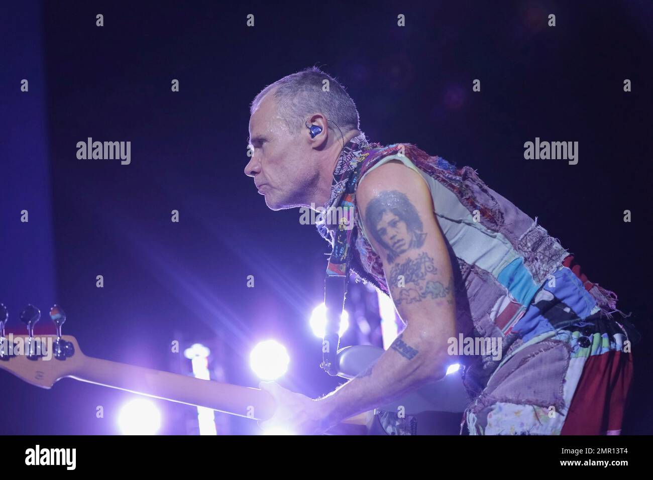 Bassist Flea, from The Red Hot Chili Peppers, performs on stage during ...