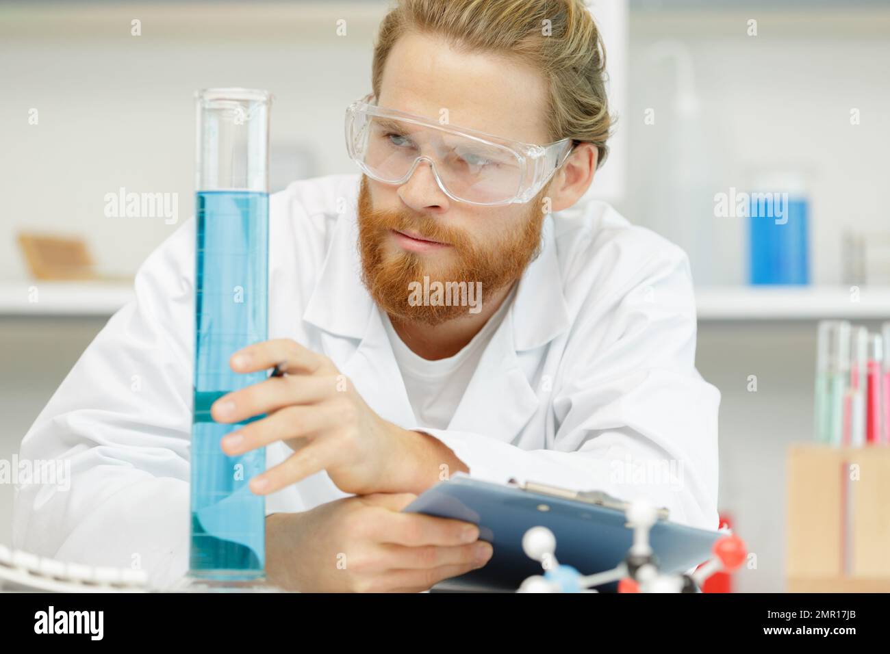 Laboratory worker uses glass pipette hi-res stock photography and ...