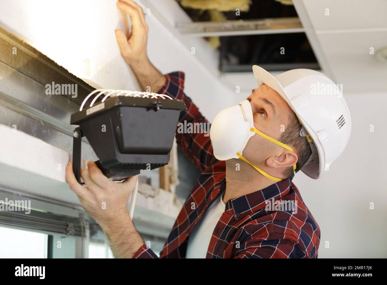 contractor using a lamp to inspect roof area Stock Photo - Alamy