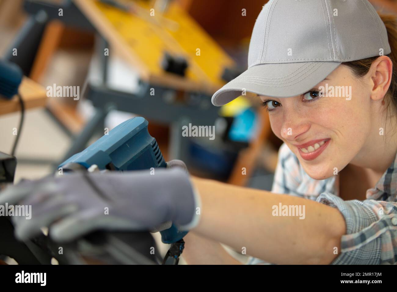 female carpenter at work using hand drilling machine Stock Photo - Alamy