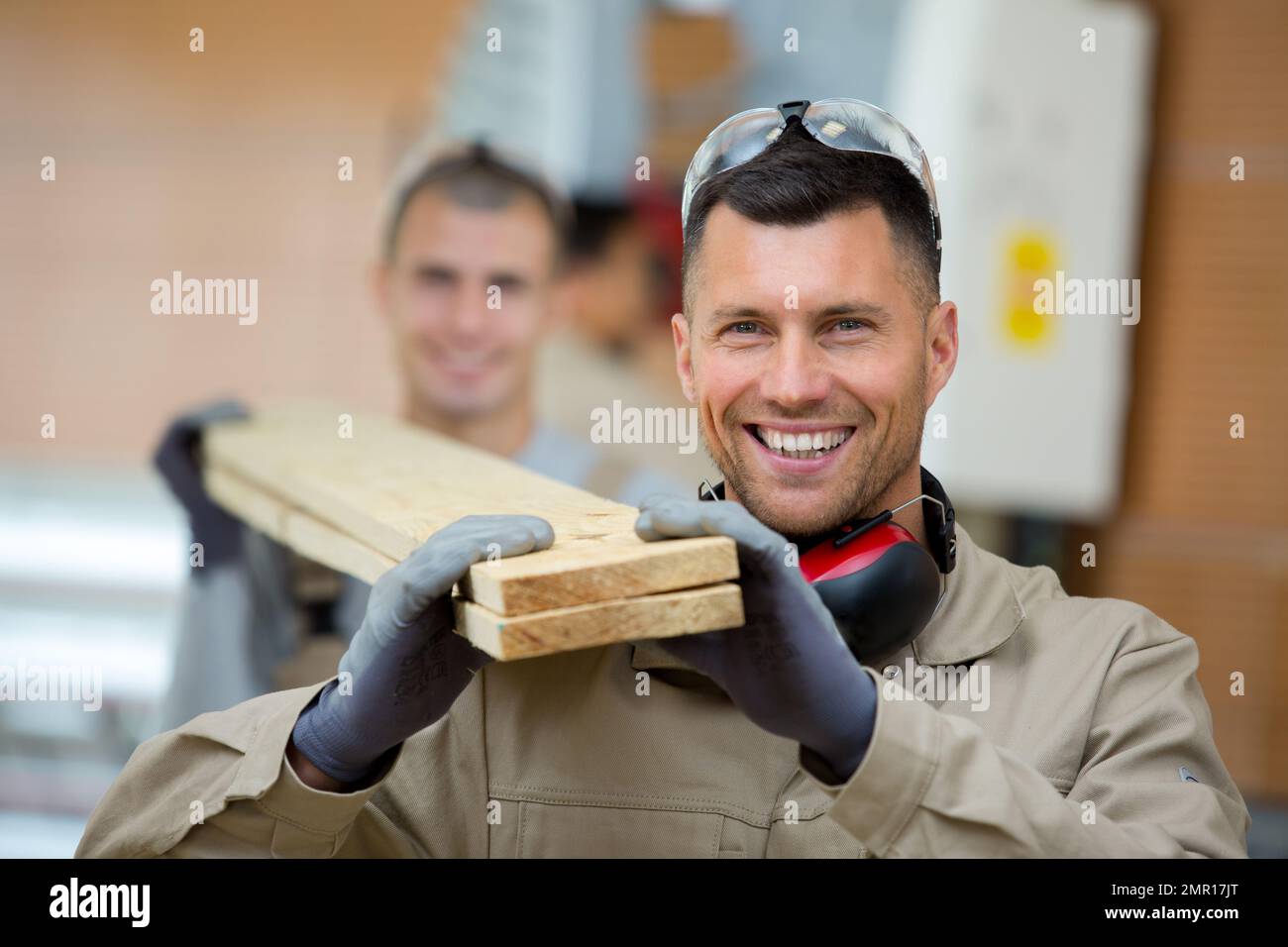 Man carrying wood planks hi-res stock photography and images - Alamy