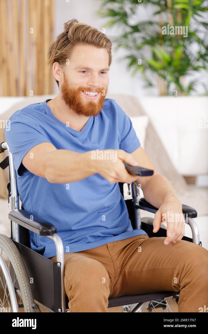 man in wheelchair watching tv Stock Photo - Alamy