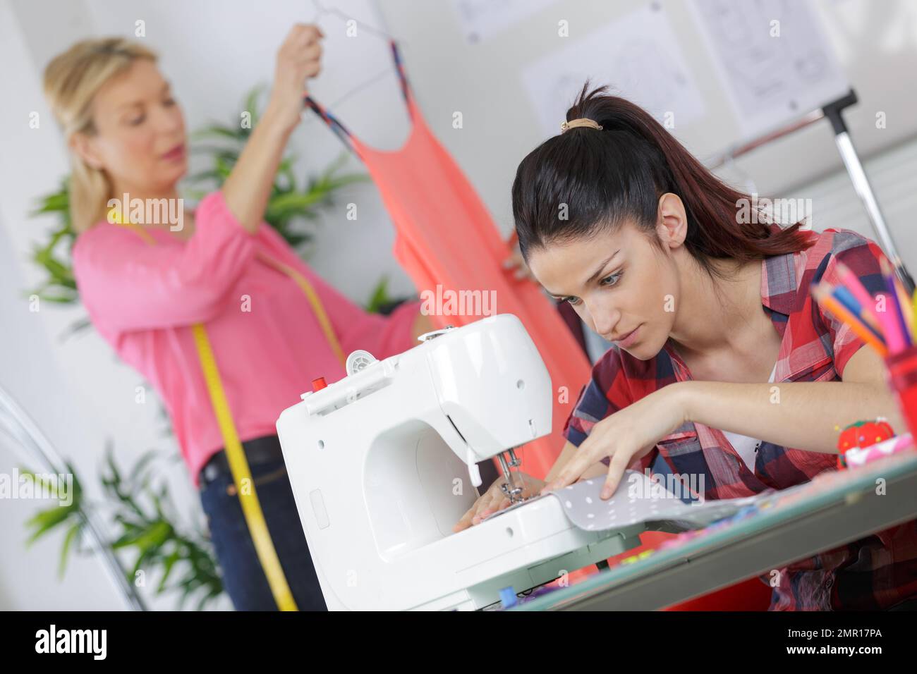 two women working in dressmaking studio Stock Photo - Alamy
