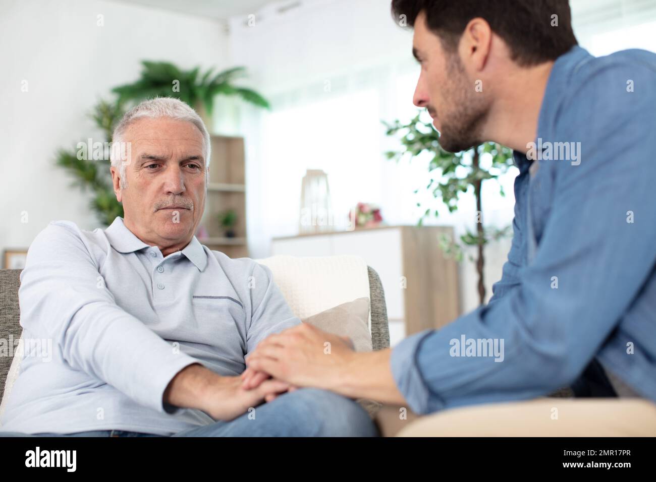Son consoling sad father home hi-res stock photography and images - Alamy