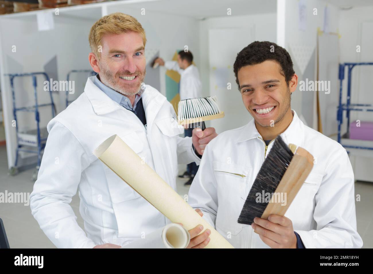 happy teacher and apprentice learning how to paint Stock Photo - Alamy