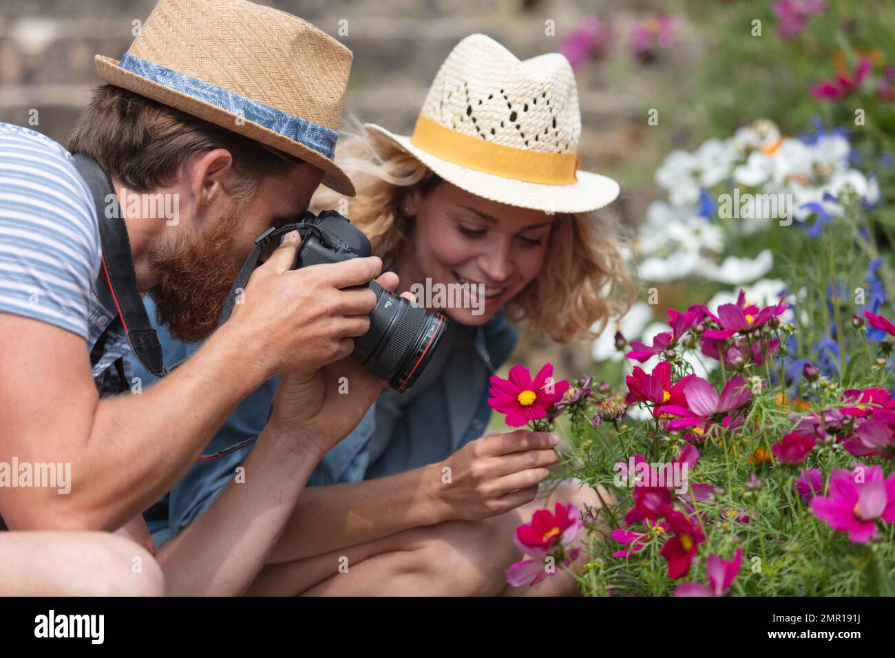 happy lovers taking photos of flowers Stock Photo - Alamy