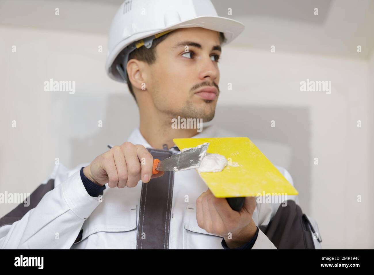 Plastering man wall helmet hi-res stock photography and images - Alamy