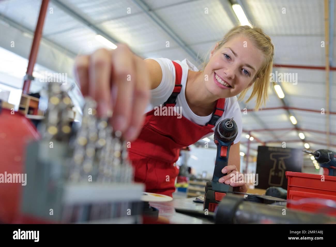 female laborer picking drilling pin Stock Photo - Alamy