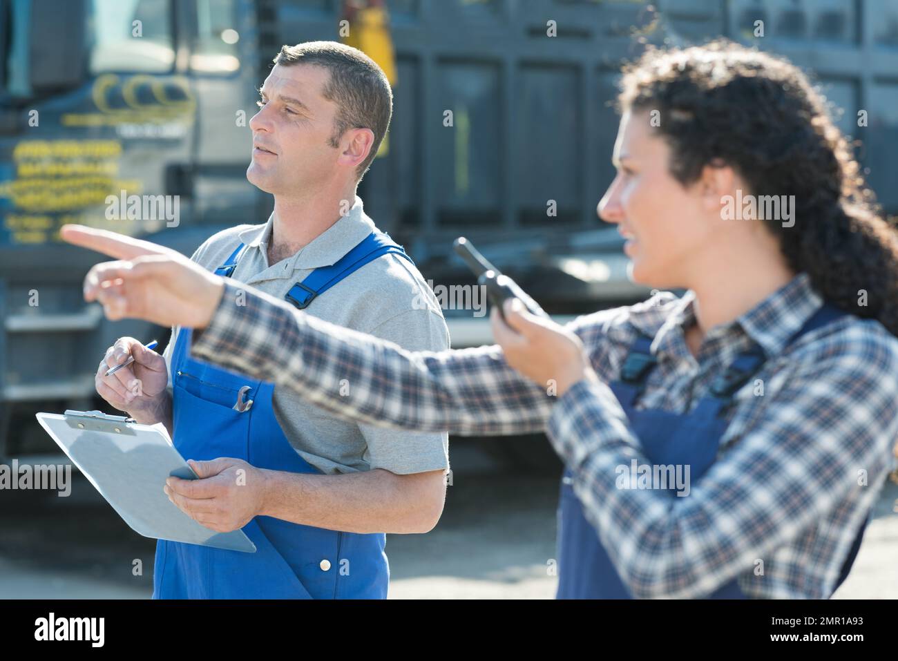 workers giving instruction through walkie talkie Stock Photo - Alamy