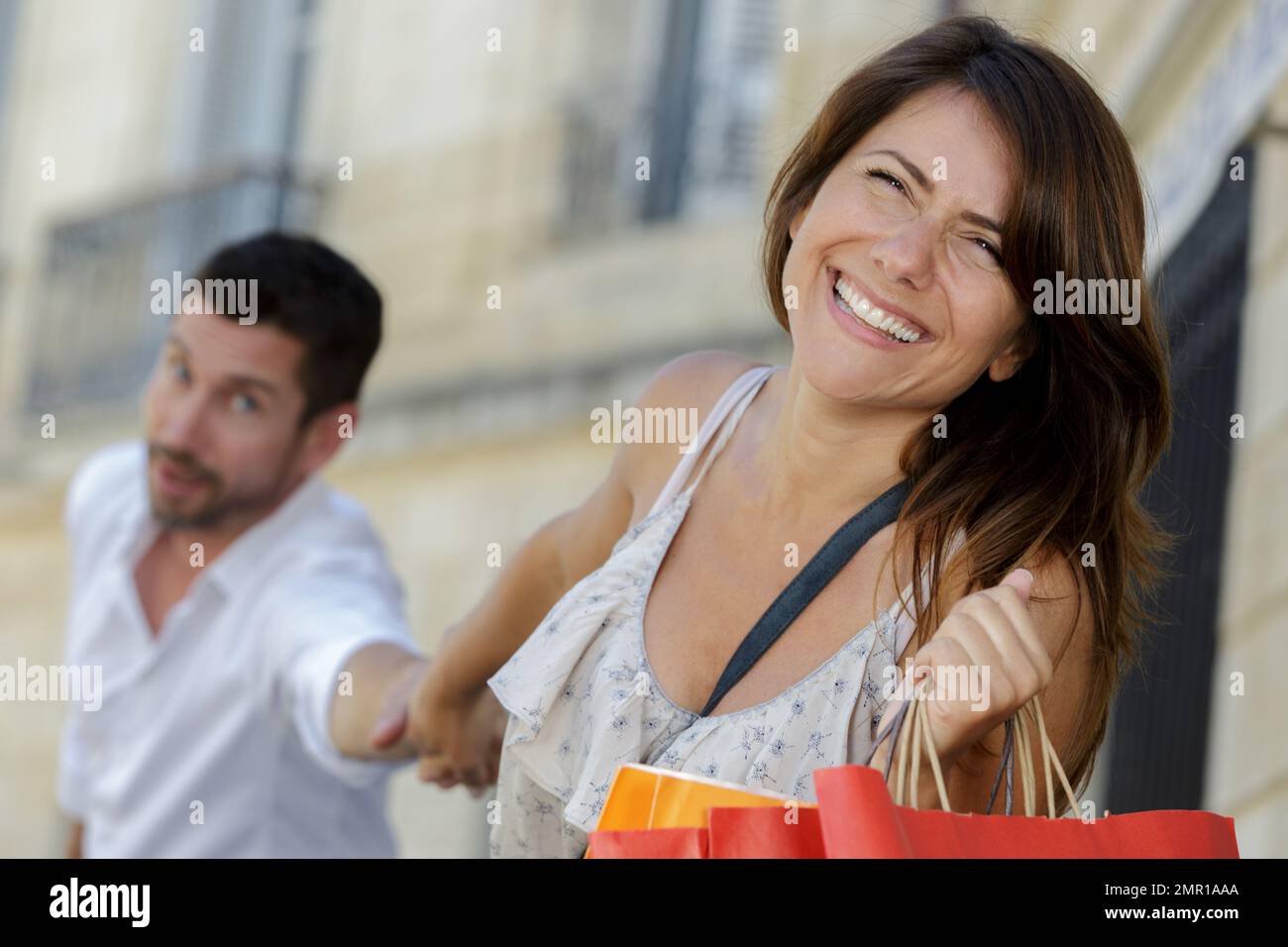 portrait of a boyfriend being dragged with girlfriend Stock Photo - Alamy
