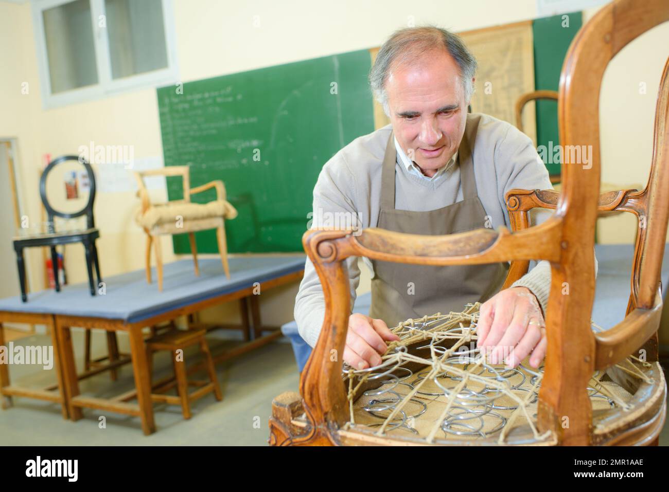 senior mender of chairs at work Stock Photo - Alamy