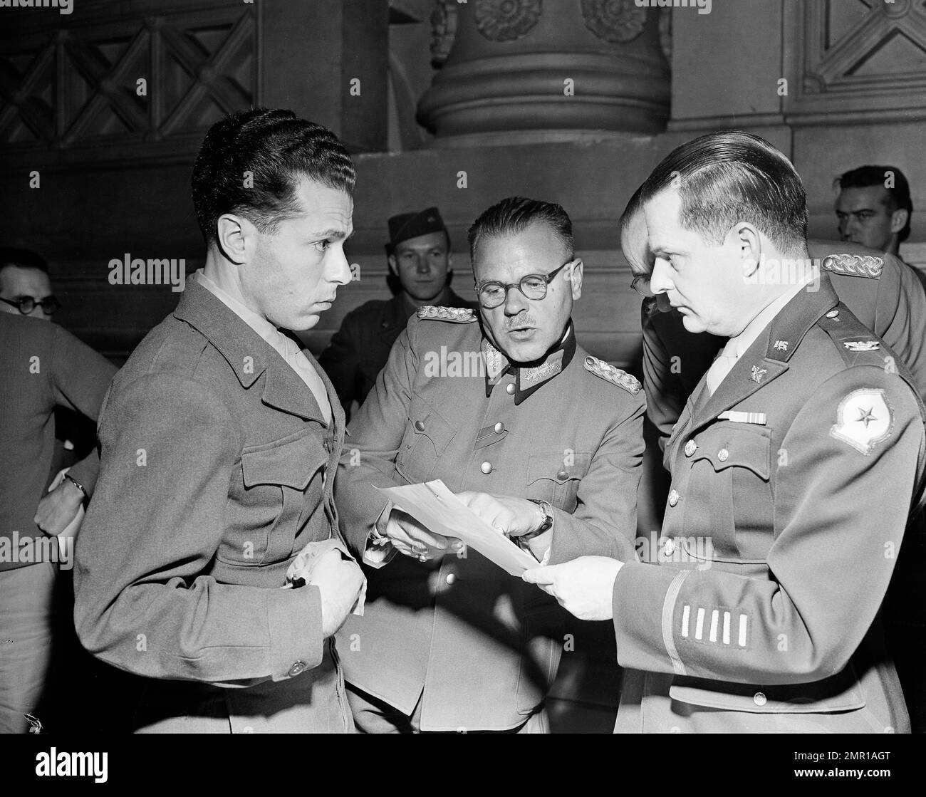 General Anton Dostler, center, explains a passage of a document to Col ...