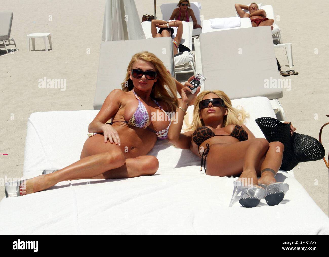 Shauna Sand and Playboy Radio Host, Taylor Wane, give the photographers ...
