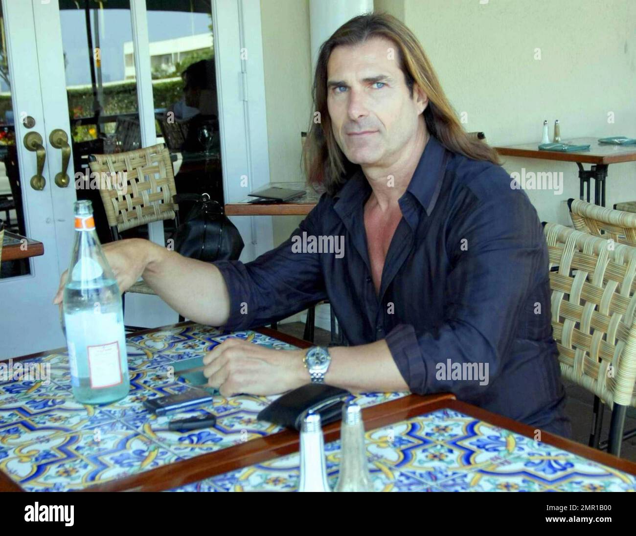 EXCLUSIVE!! Fabio sits at a table as he waits for a friend to arrive ...