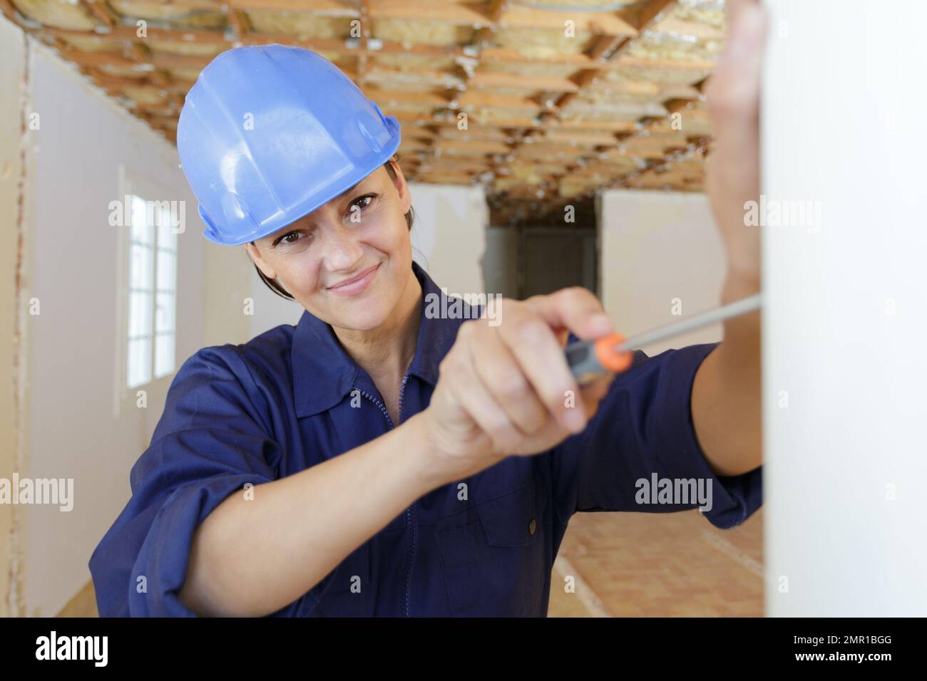 women use screwdriver in site Stock Photo - Alamy