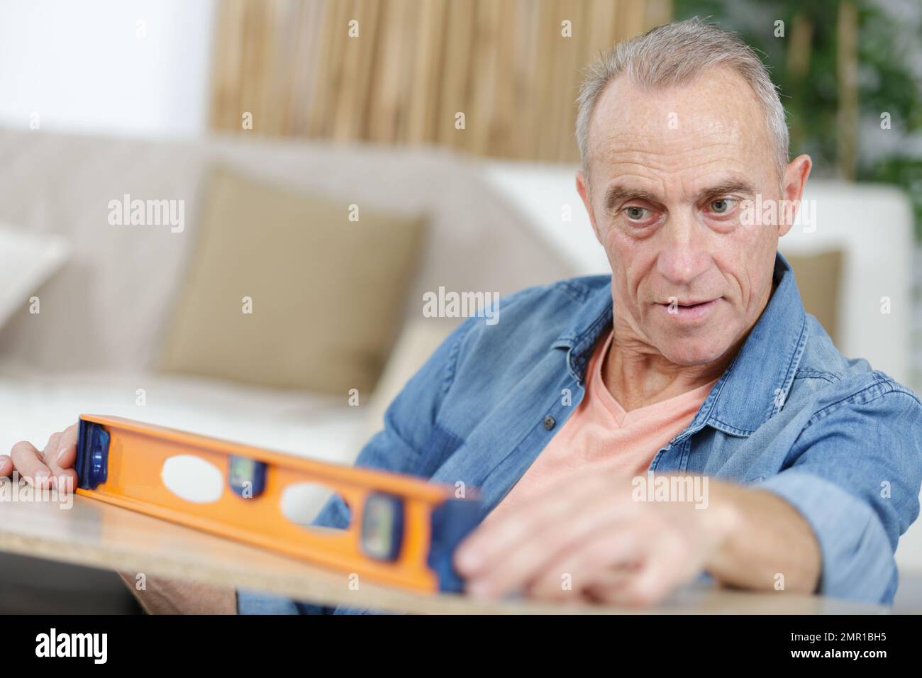 senior constructor holding a ruler Stock Photo - Alamy