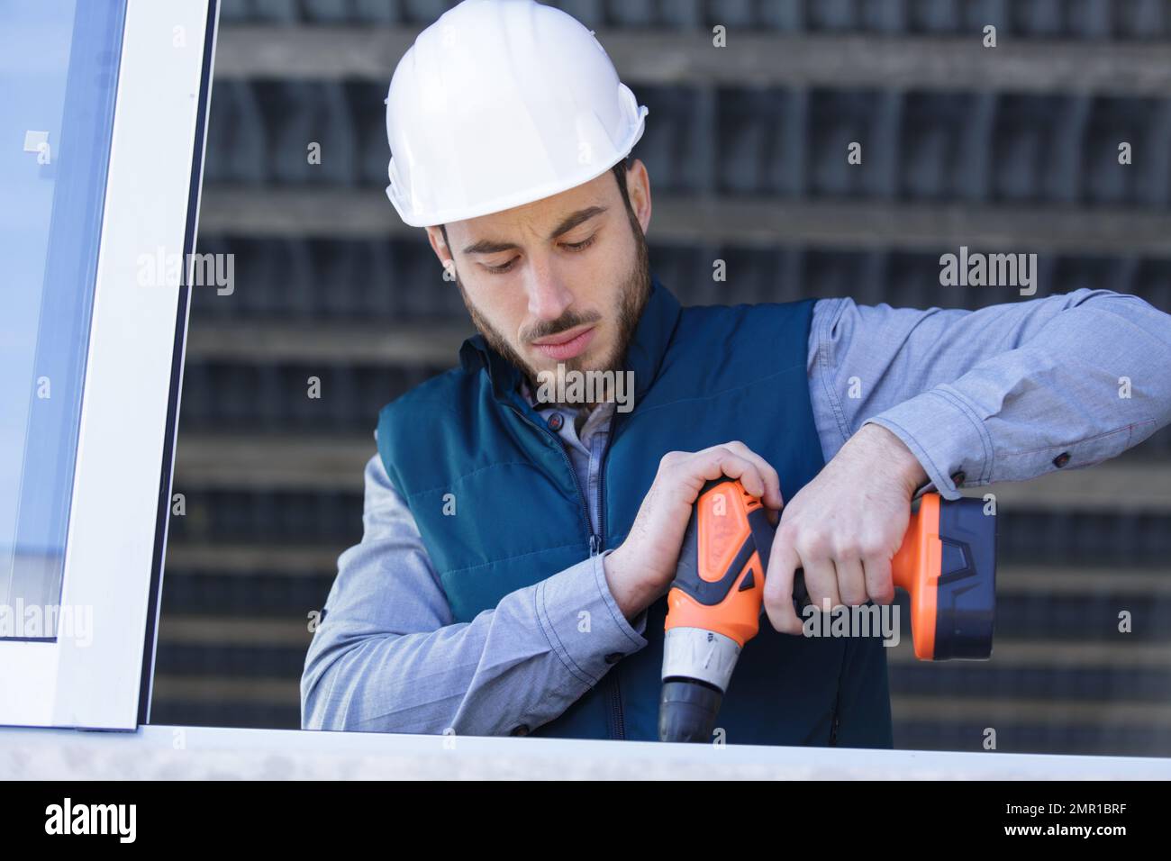 construction worker using drill to wood Stock Photo - Alamy