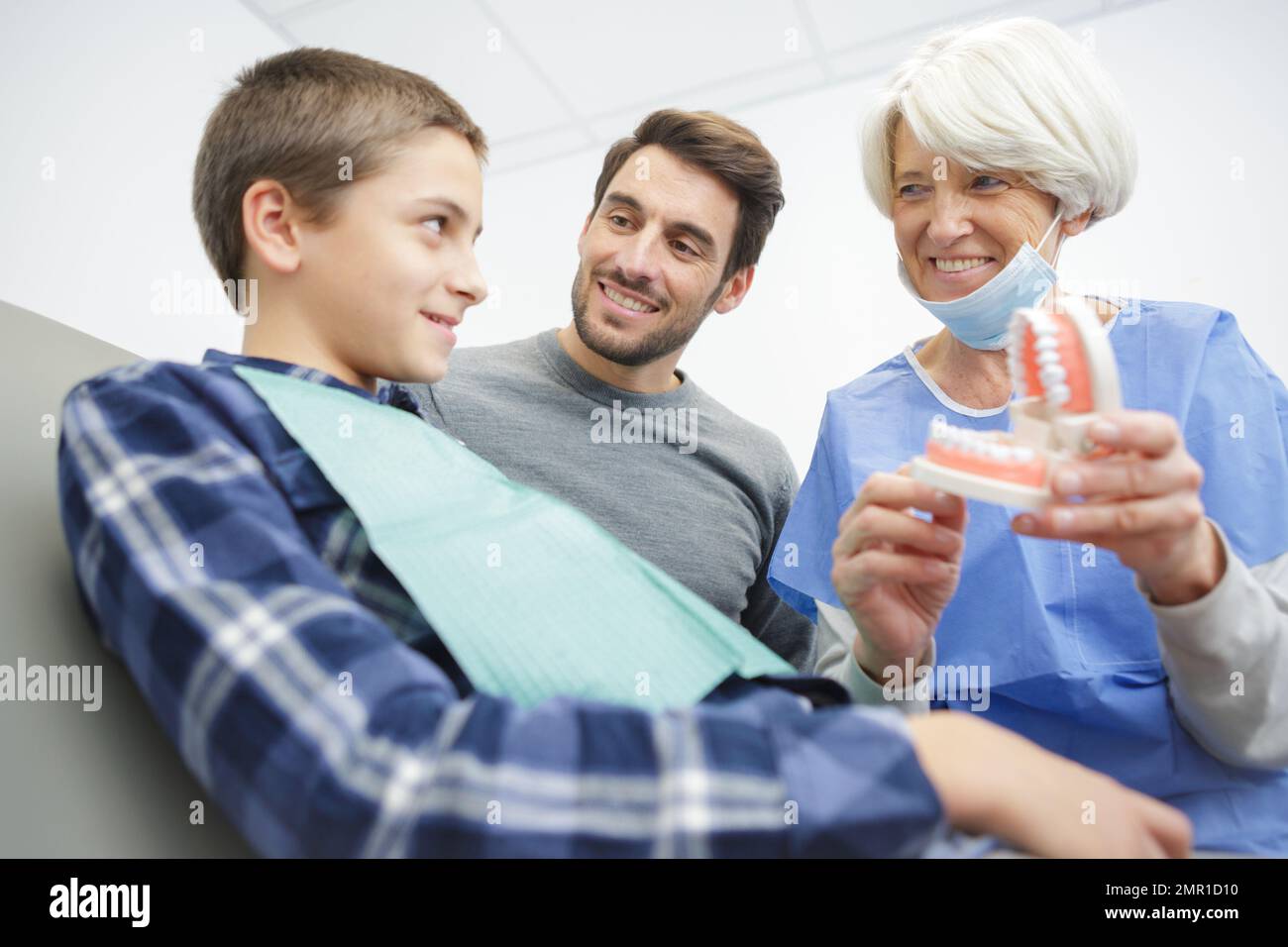 female dentist shows dentures to little boy Stock Photo - Alamy