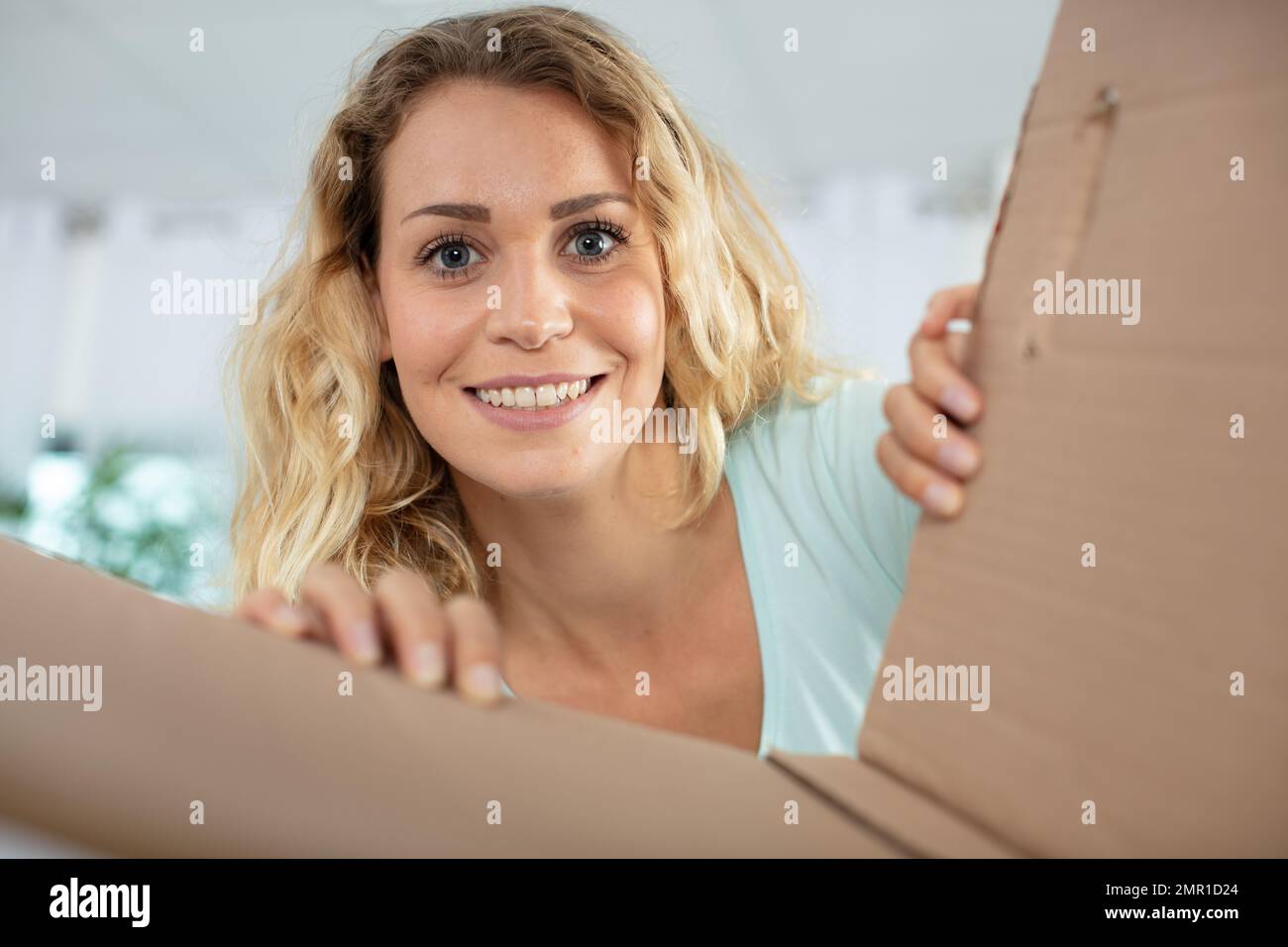 beautiful young woman opening box with parcel Stock Photo - Alamy