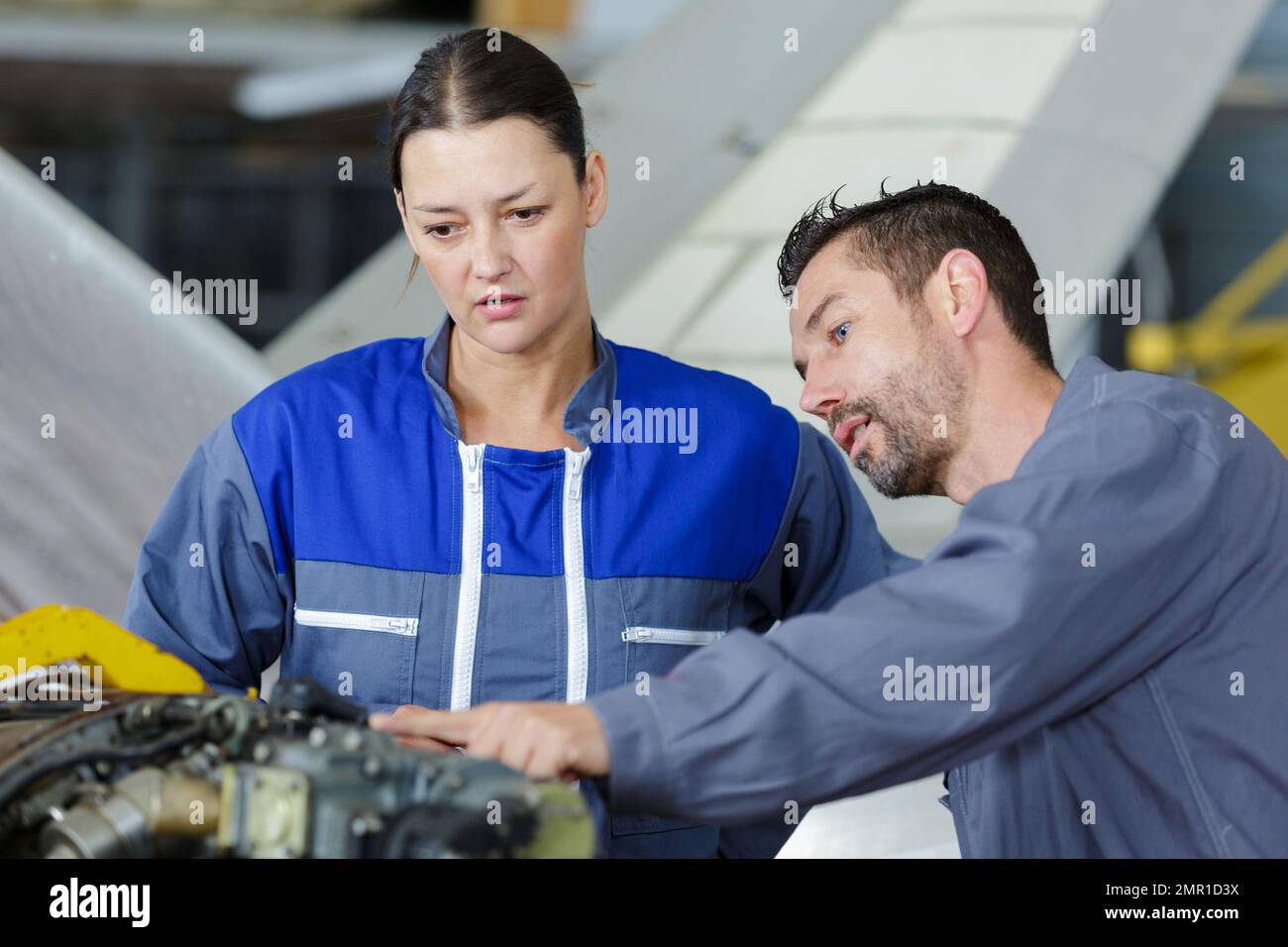 portrait of engineers working on an engine Stock Photo - Alamy