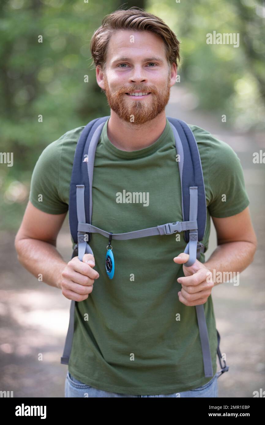 young man hiking smiling happy portrait walking in forest Stock Photo ...