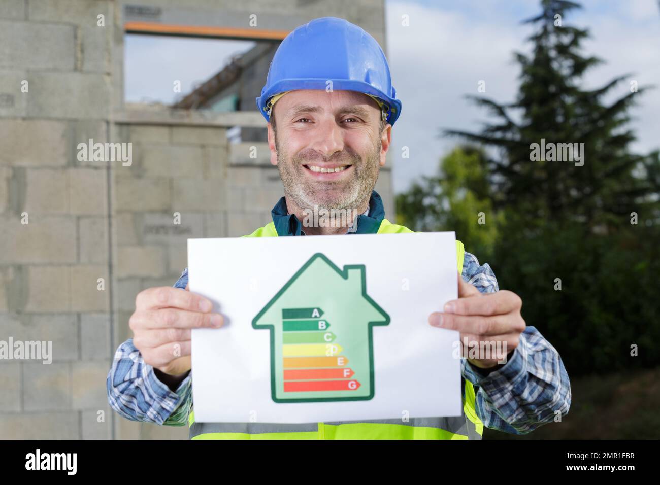 happy builder showing a paper chart Stock Photo - Alamy