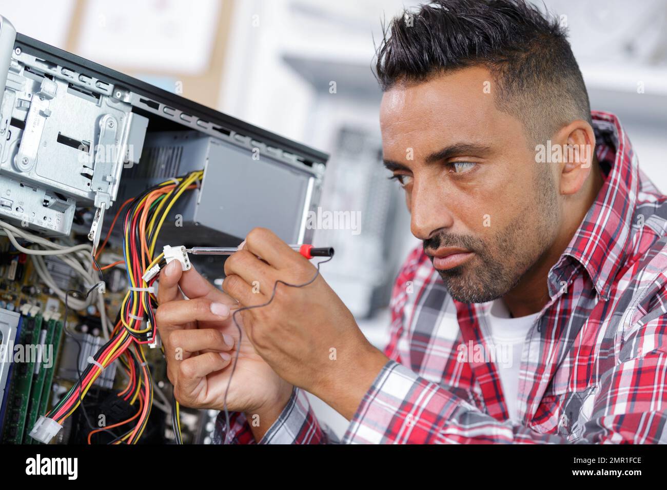 a man is fixing a pc Stock Photo - Alamy