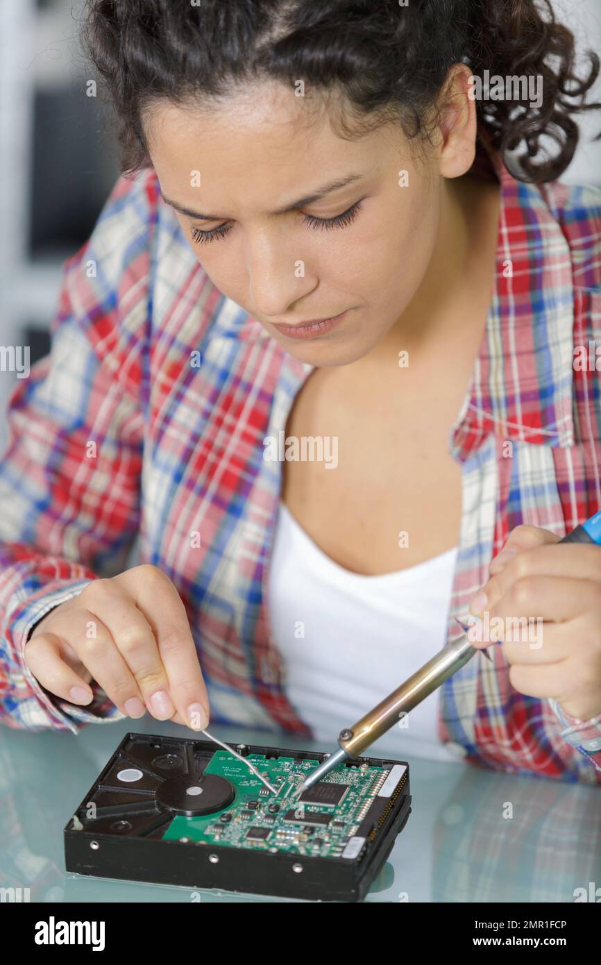 young female electronic engineer soldering computer motherboard Stock ...
