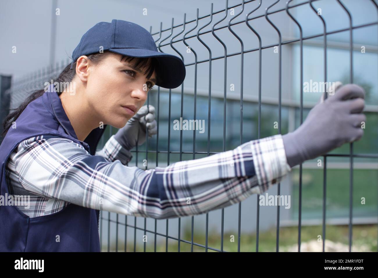 worker is checking outdoors fence Stock Photo - Alamy