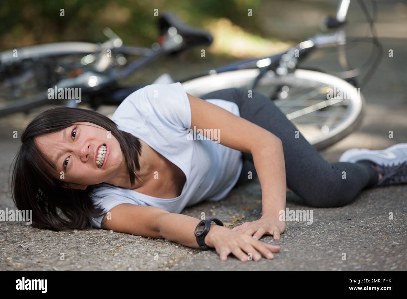 young woman cyclist in hurt and injured herself after accident Stock ...