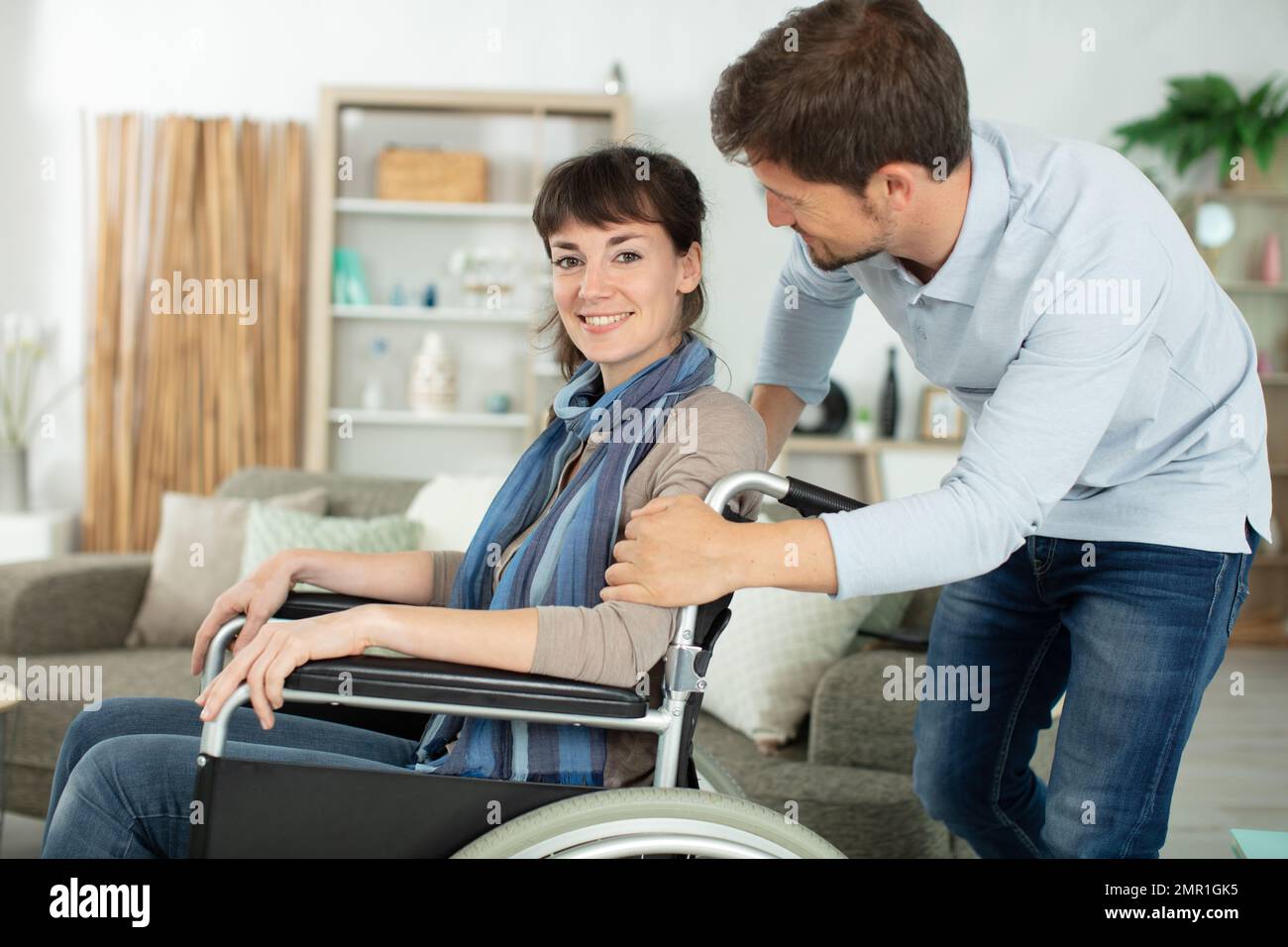 loving supportive man hugging handicapped wife Stock Photo - Alamy
