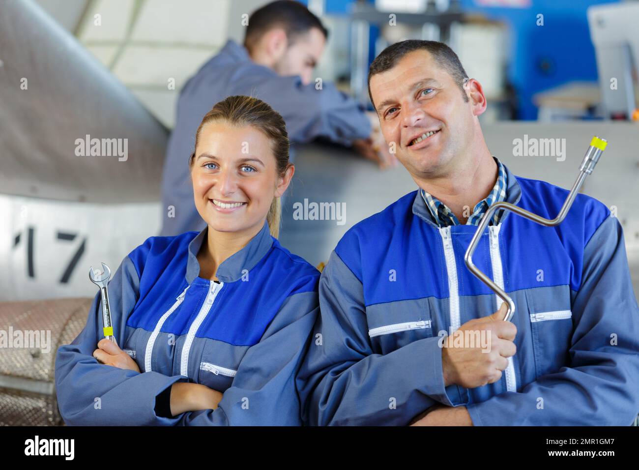 two mechanics work with the details of the car Stock Photo - Alamy
