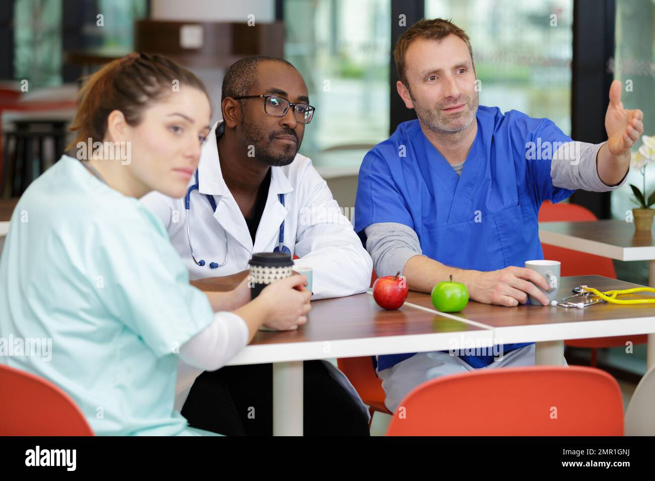 group of doctors in the cafeteria eating relaxing small talk Stock ...