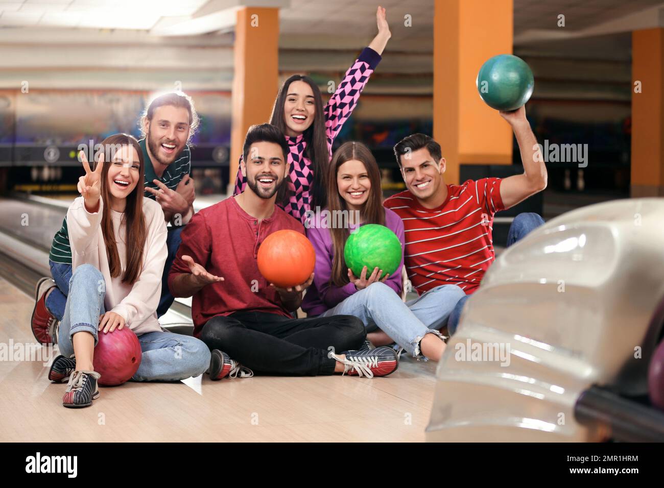 Group of friends with balls in bowling club Stock Photo - Alamy